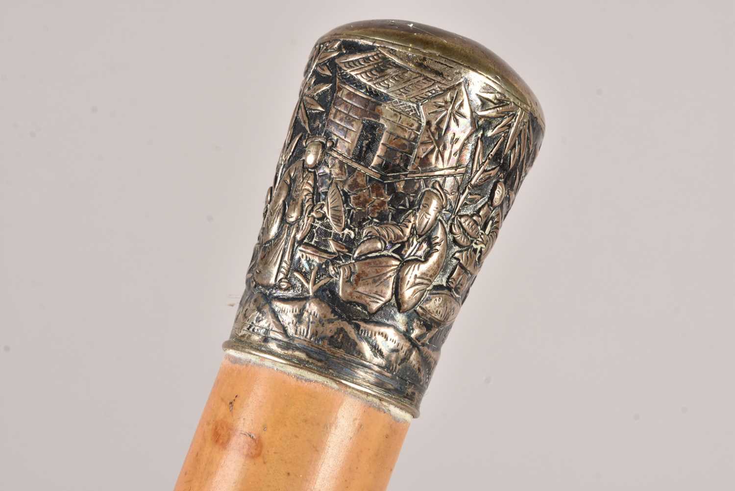 Lot 88 - A white metal topped Oriental walking cane,