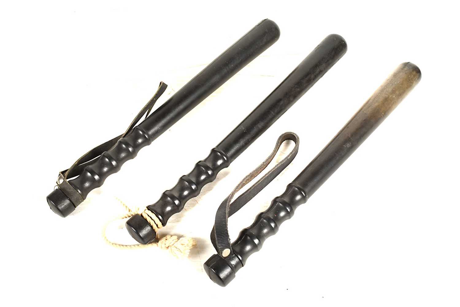 Lot 472 - Three Rubber truncheons,