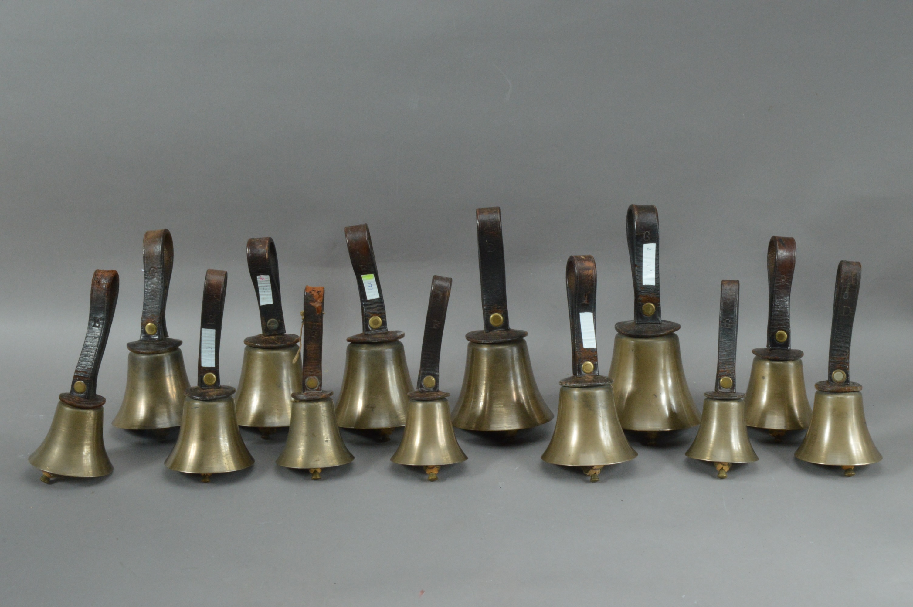 Lot 138 - A set of 14 hand bells,