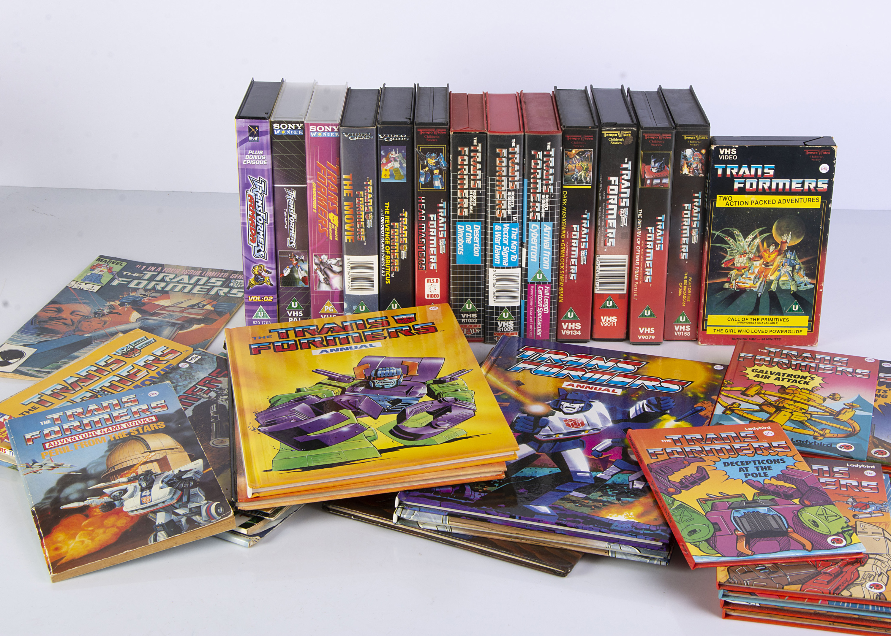 Lot 553 - Transformers VHS, Annuals & Other