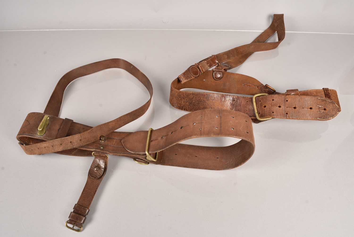 Lot 555 - Two named Sam Browne belts,