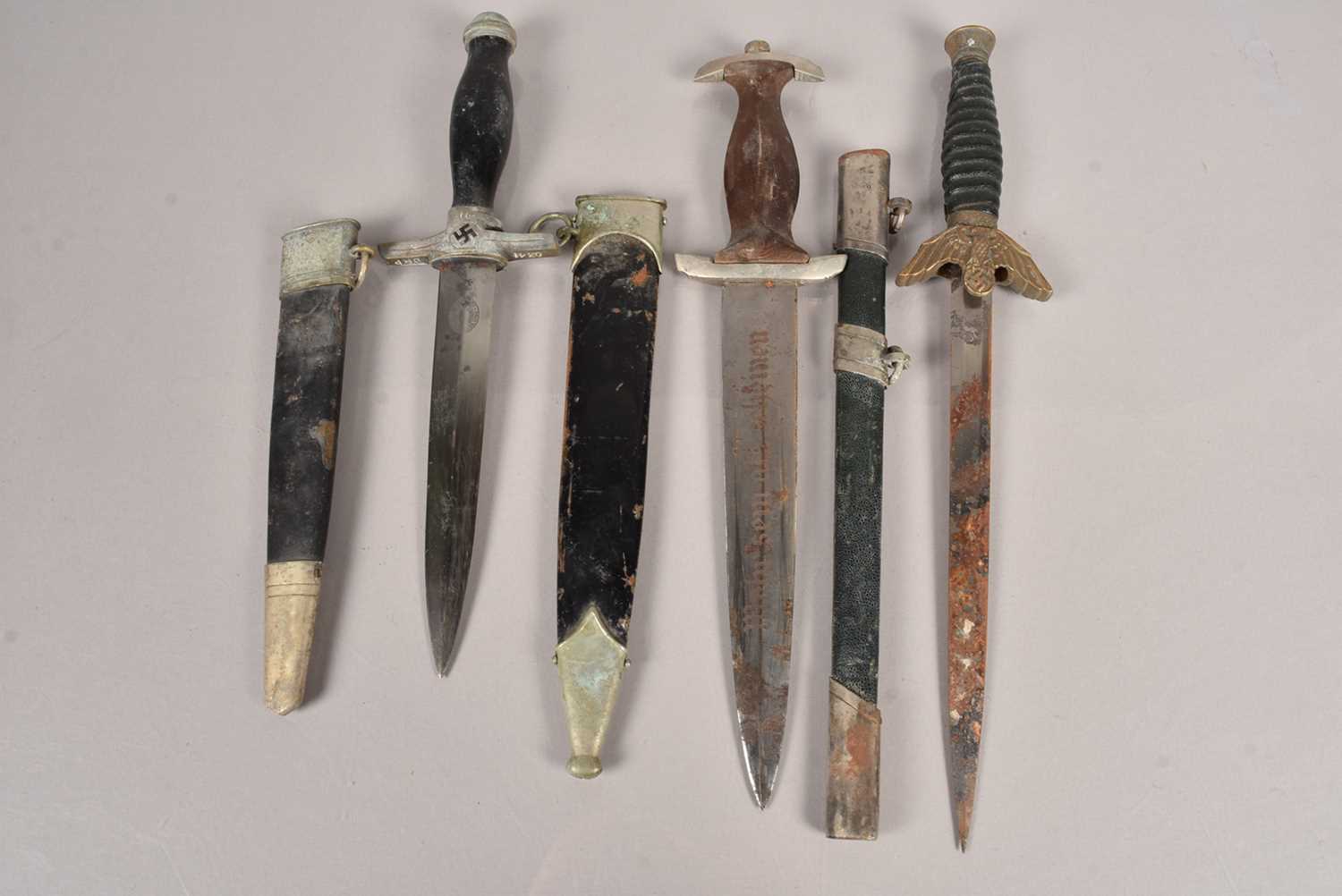 Lot 702 - Three Reproduction German daggers,