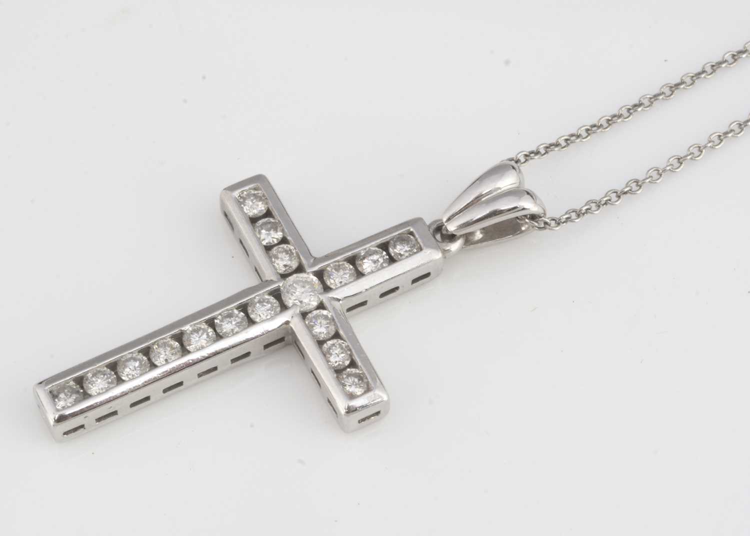 Lot 192 - A 9ct gold diamond set cross pendant,