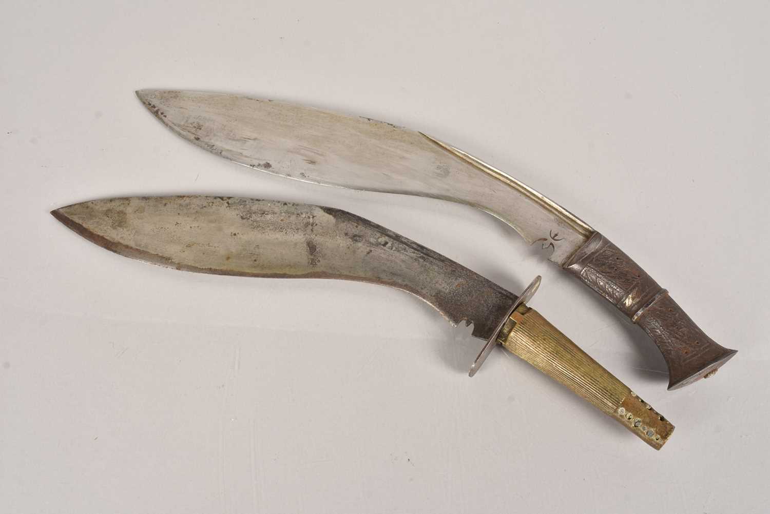 Lot 827 - Two Middle Eastern Kukri knives,