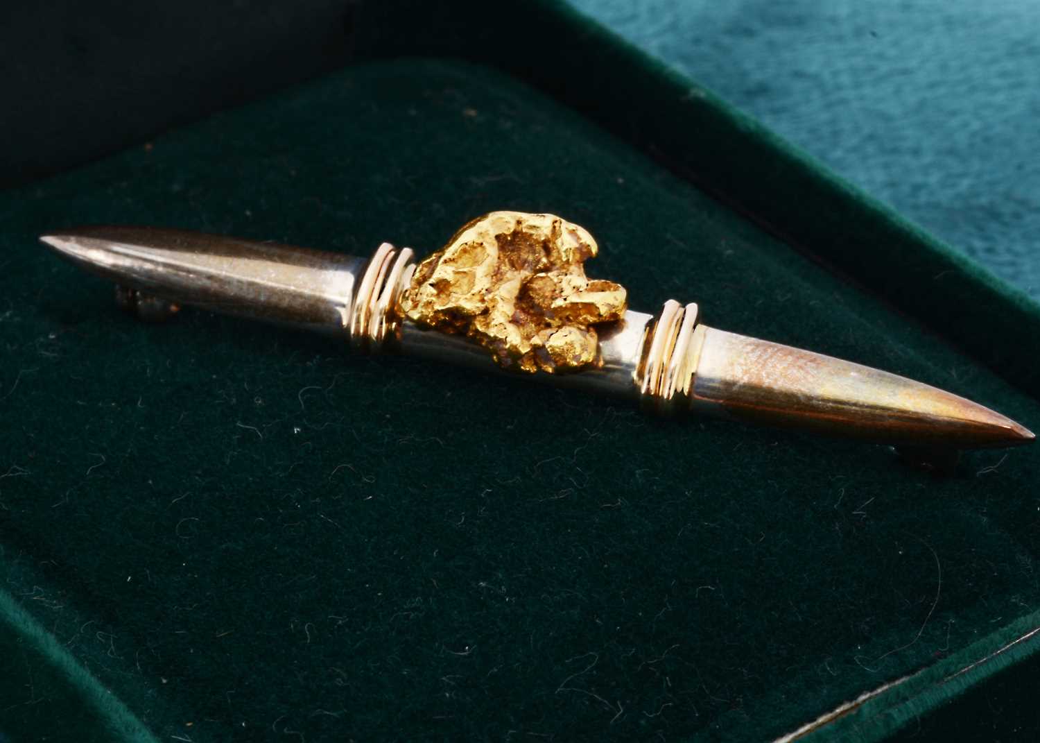 Lot 378 - A gold nugget and silver set brooch,