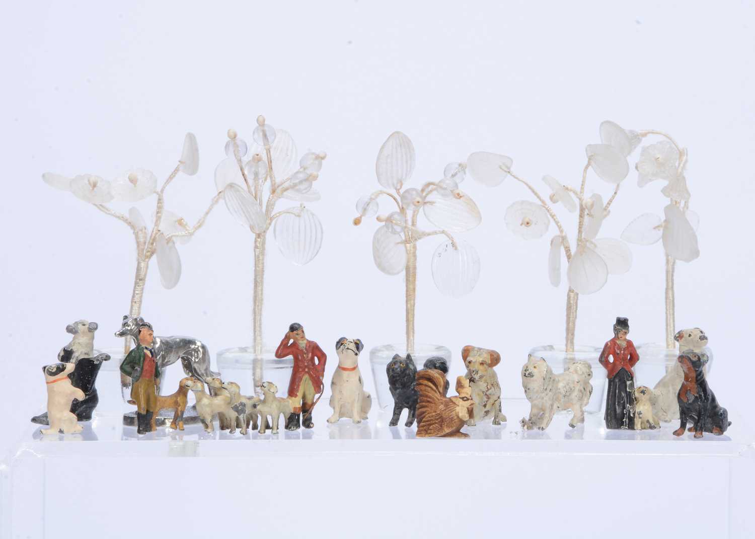 Lot 590 - Lead miniature dogs and glass pot plants,