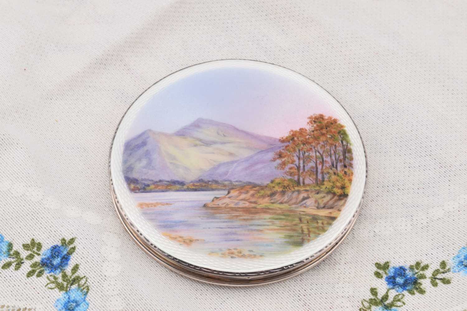 Lot 273 - A circular silver, enamelled and painted