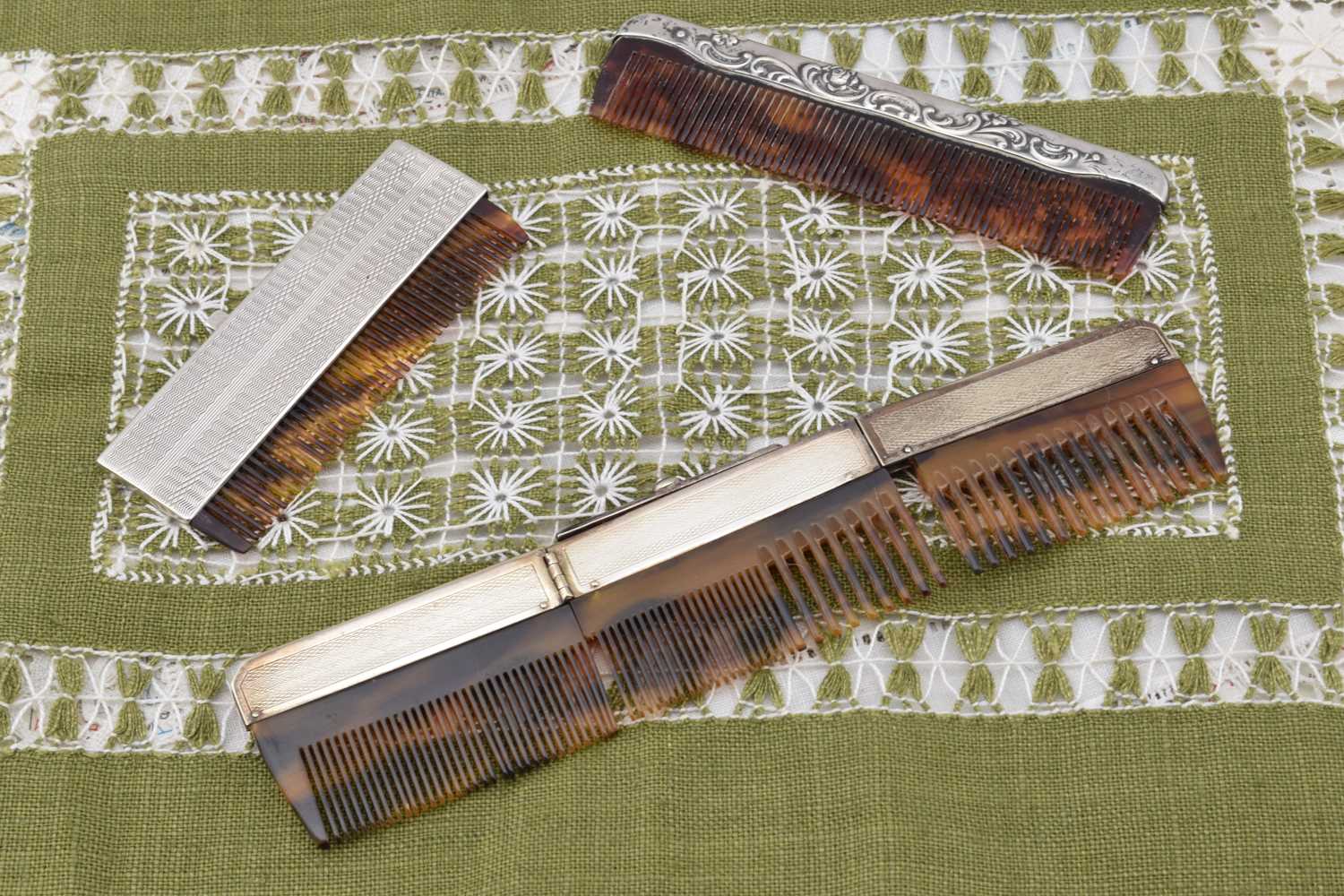 Lot 310 - Three silver mounted combs,