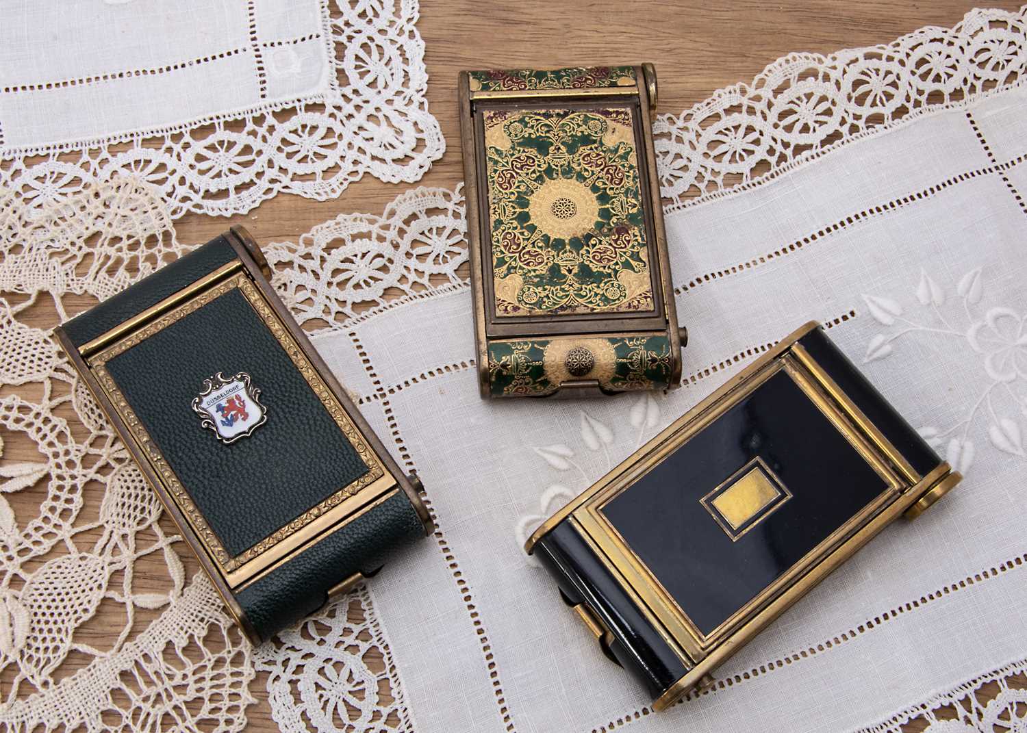 Lot 320 - Three vintage gilt metal 'Camera' compacts,
